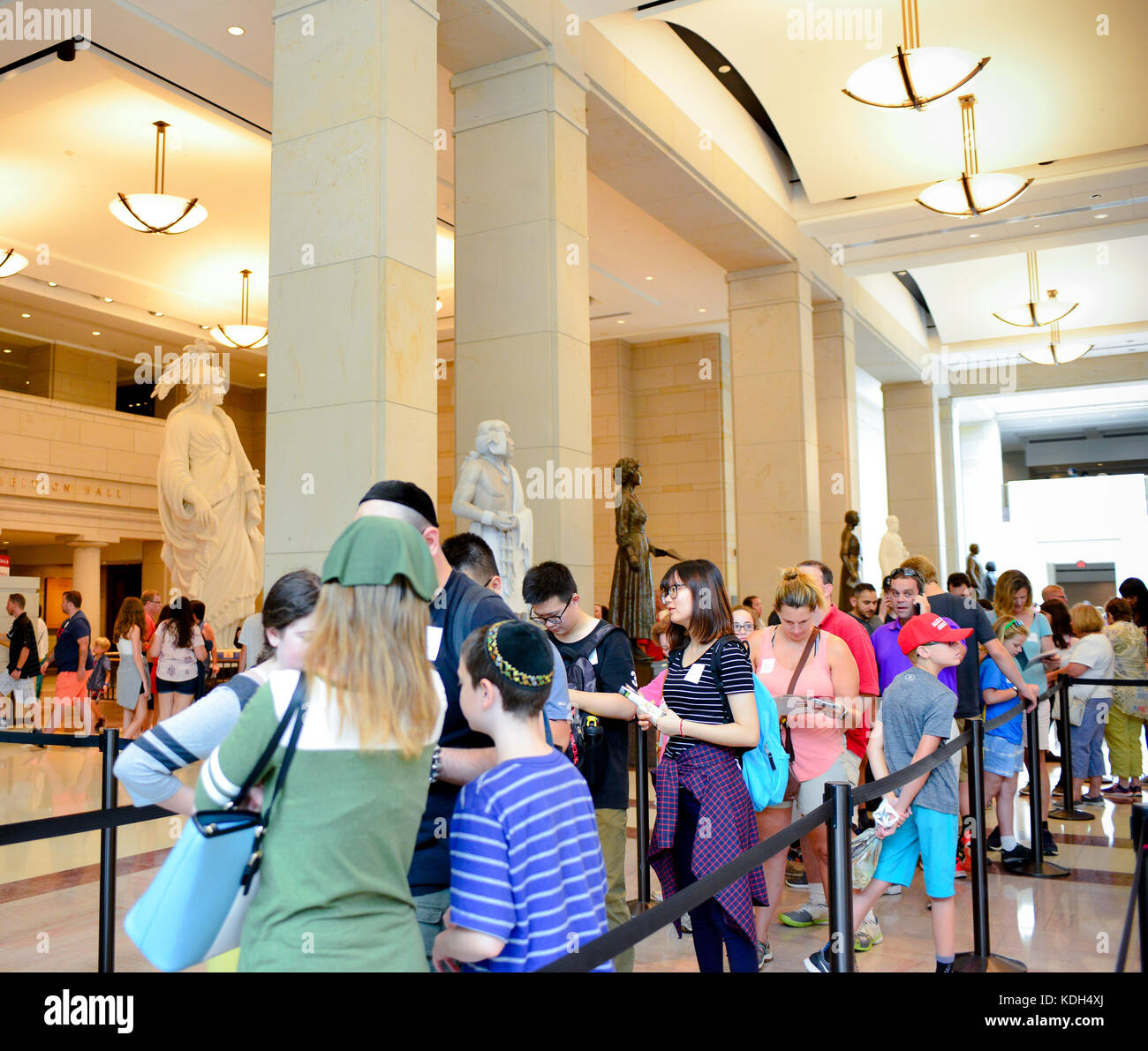 Crowds of people stand in a queue inside the US Capitol Visitors Center ...