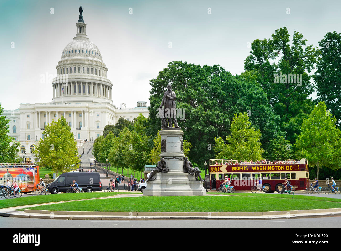 Cyclist and tour buses cruising in the circle in front of the US ...