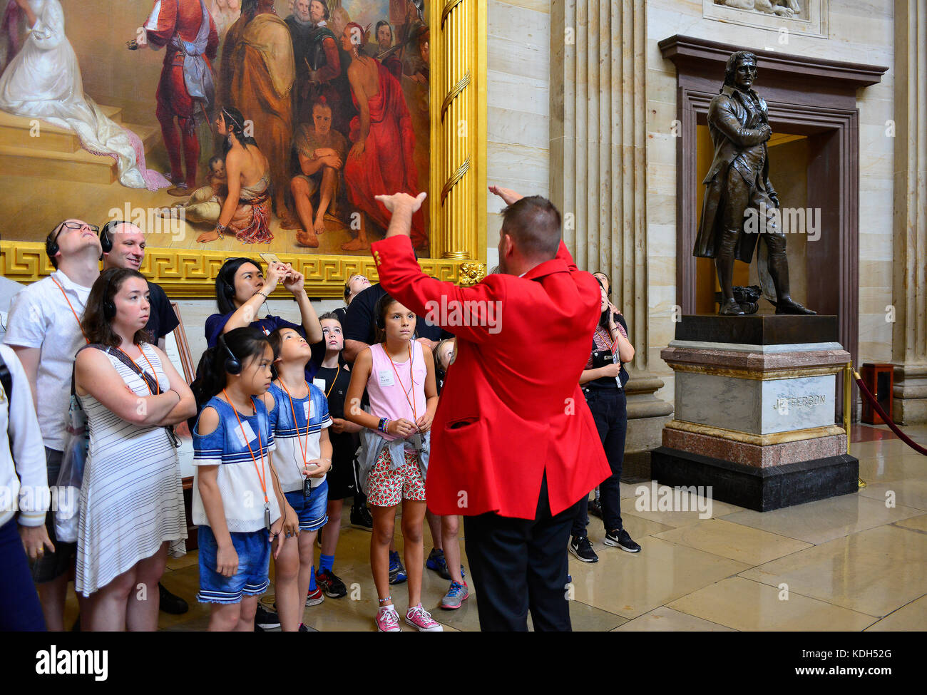 A tour guide leading Visitors inside the Rotunda at the US Capitol ...