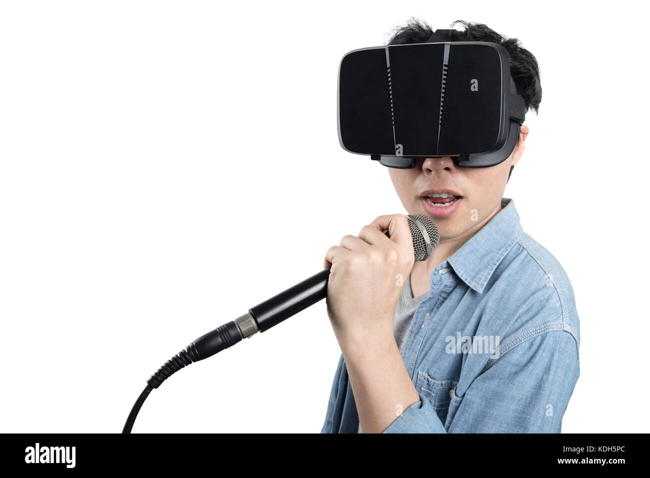 Asian man singing with VR glasses Stock Photo - Alamy