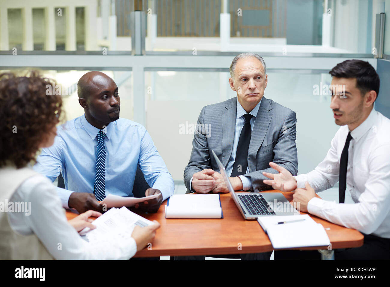 Confident coach giving advice to his colleague at briefing and ...