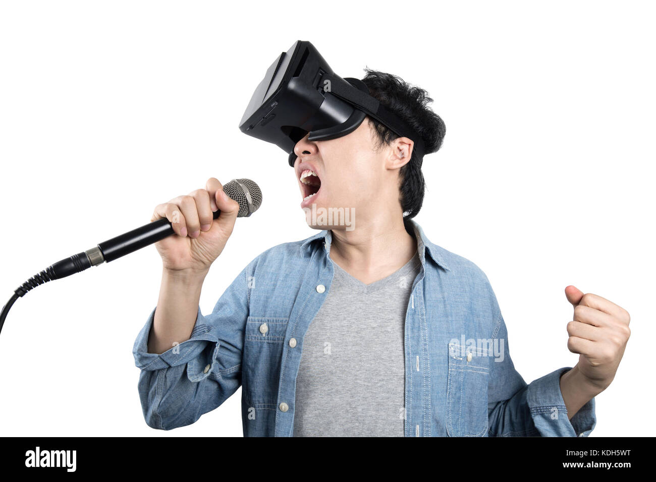 Asian man singing with VR glasses Stock Photo - Alamy