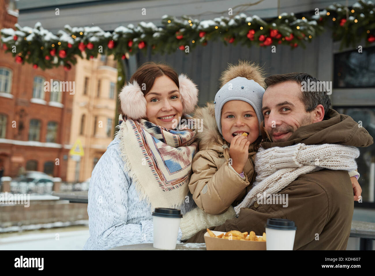 Hungry family eating french fries and having hot drinks outdoors Stock ...