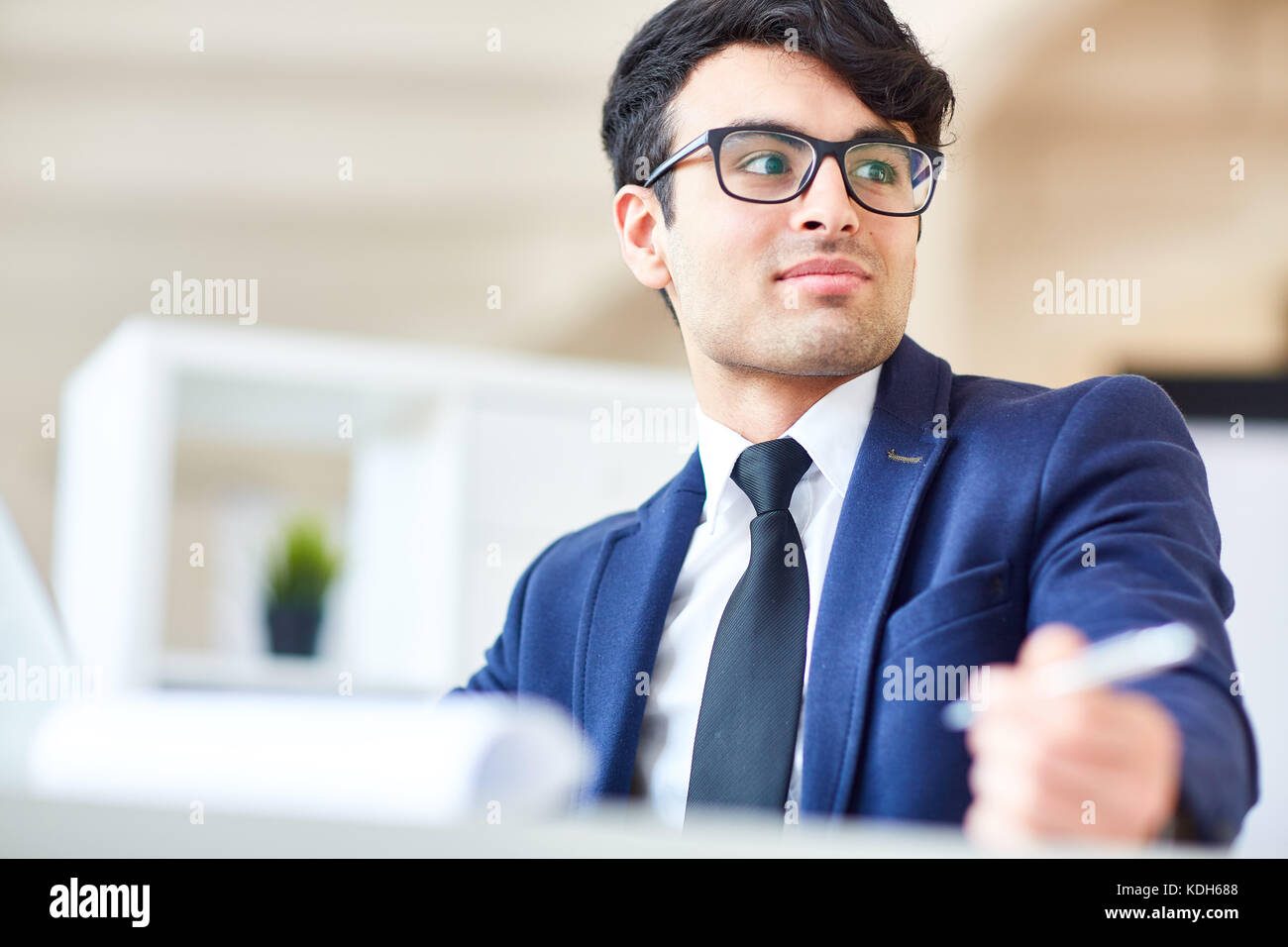 Confident manager looking at someone during business conversation Stock ...