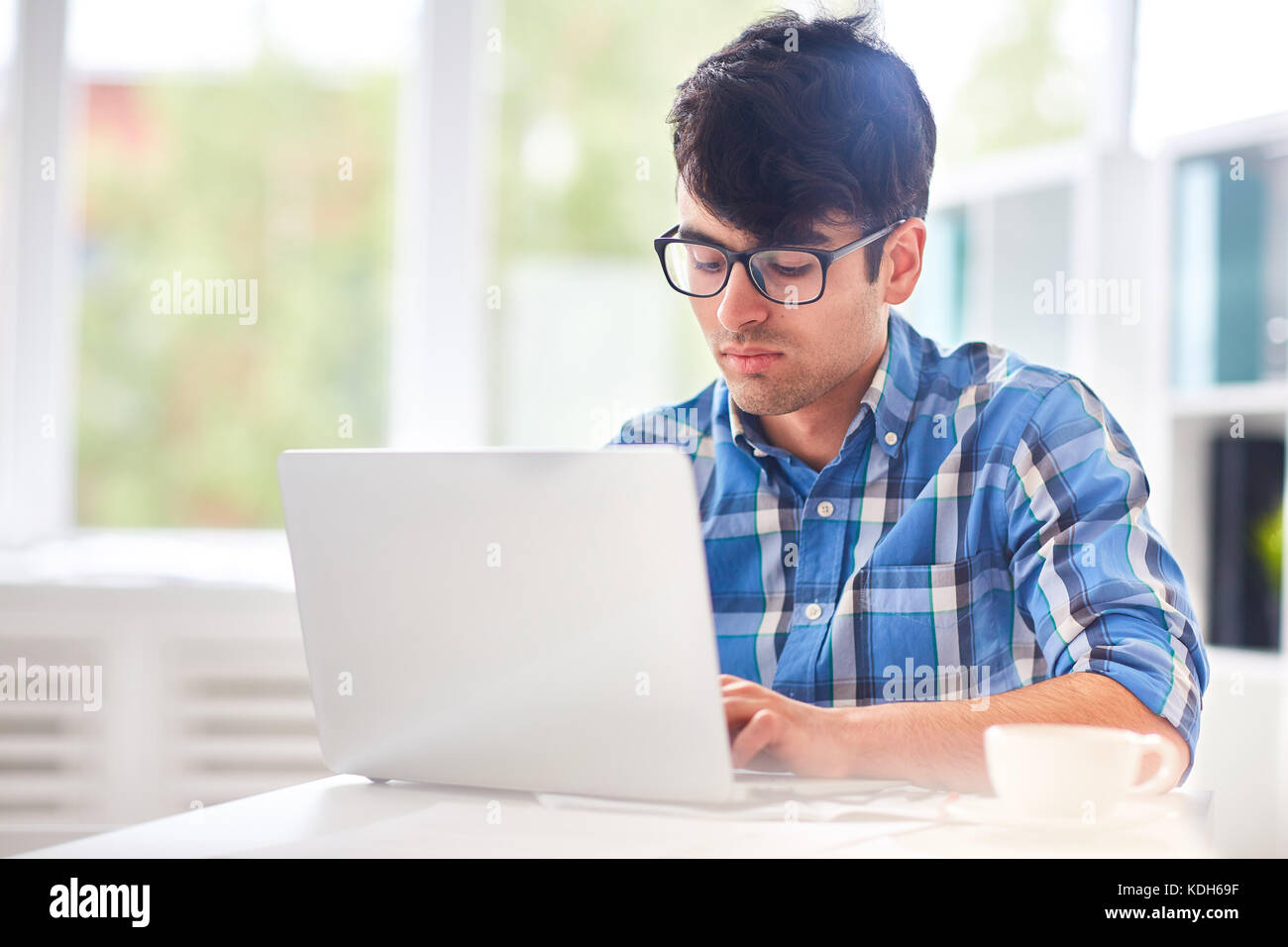 Modern guy typing on laptop while analyzing data in the net Stock Photo ...