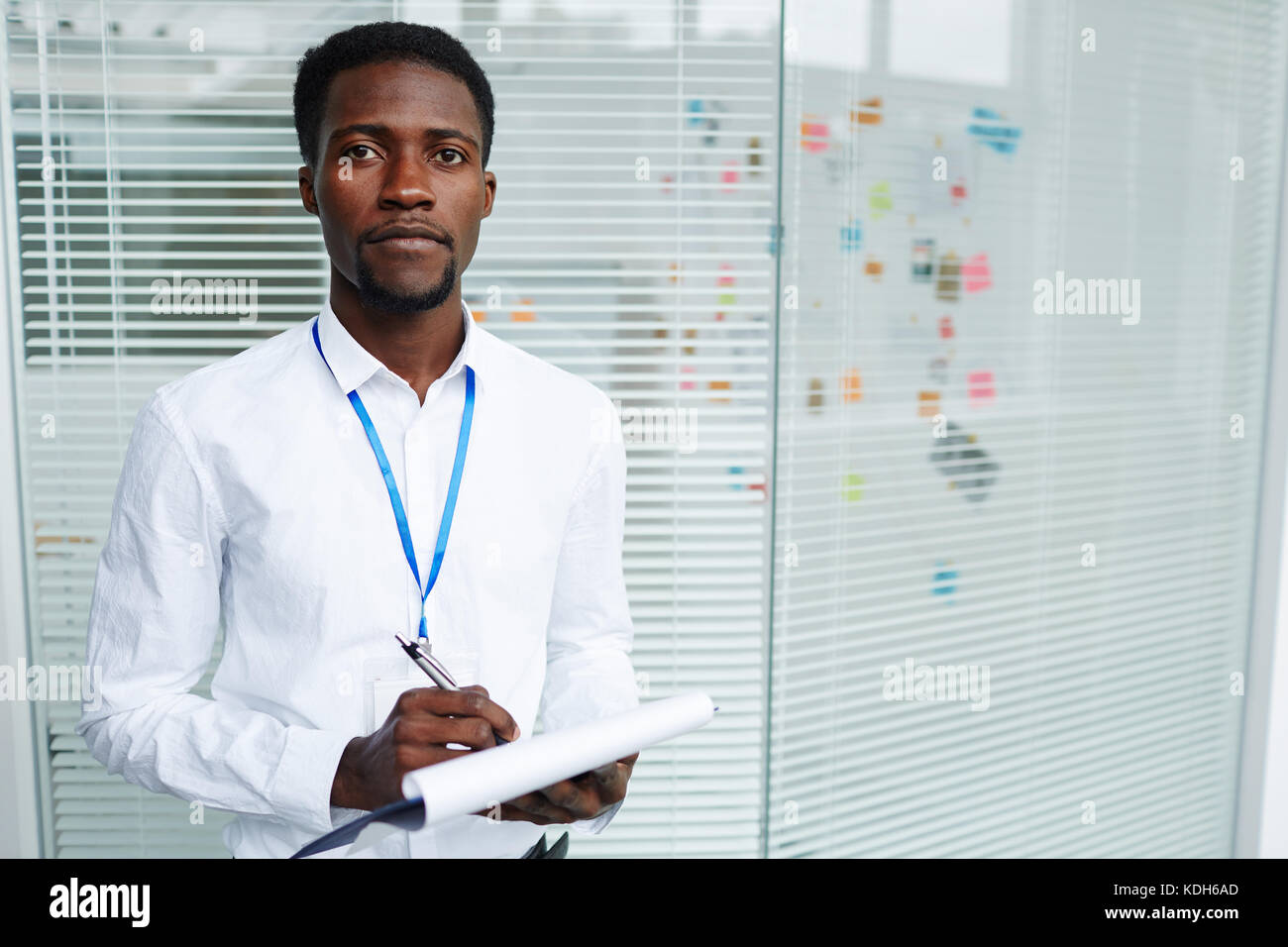 Confident officer making notes on paper while investigating air crash ...