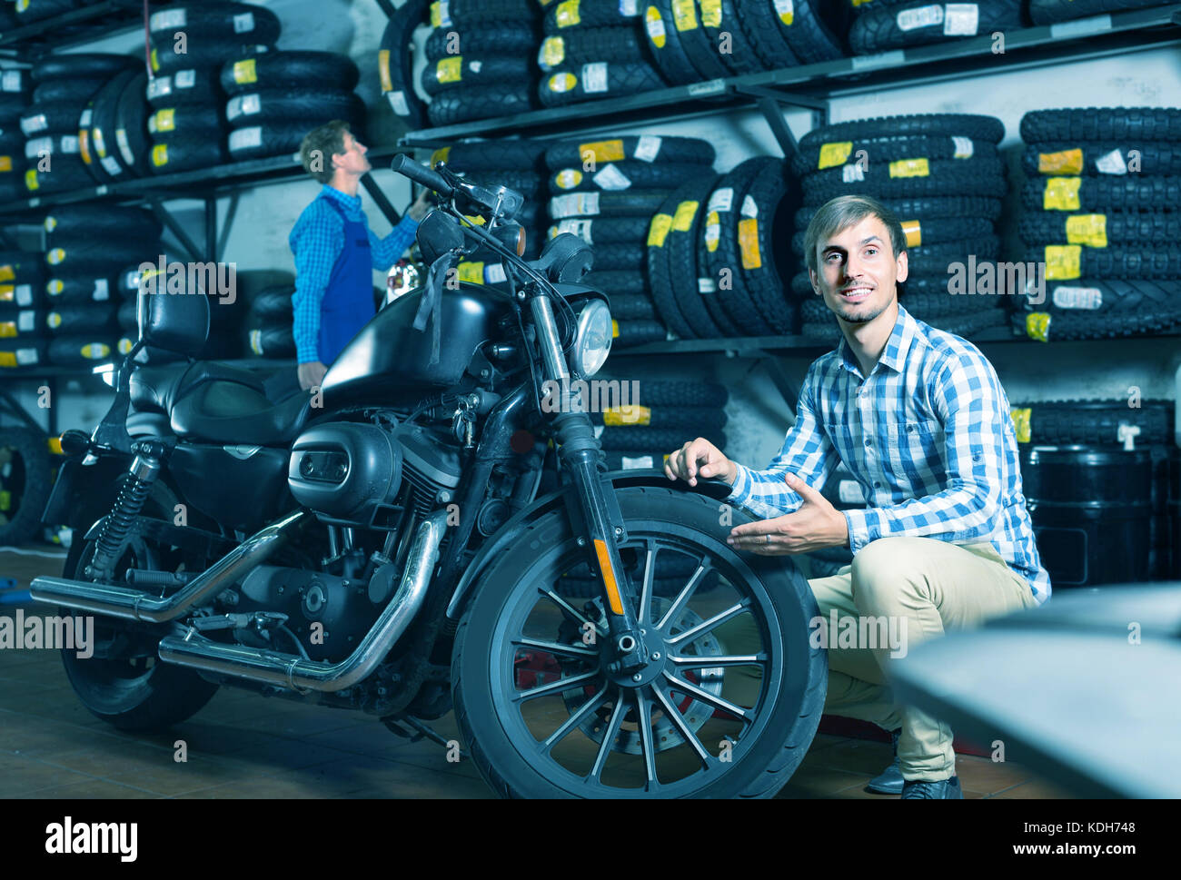Young man customer buying motorcycle at service point Stock Photo - Alamy