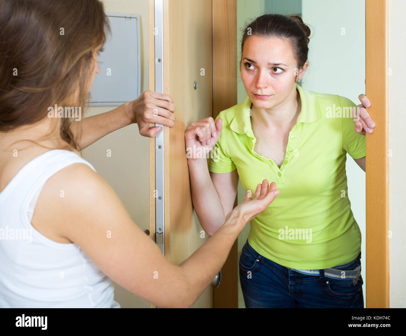 Two angry young female neighbours having conflict at the door Stock ...