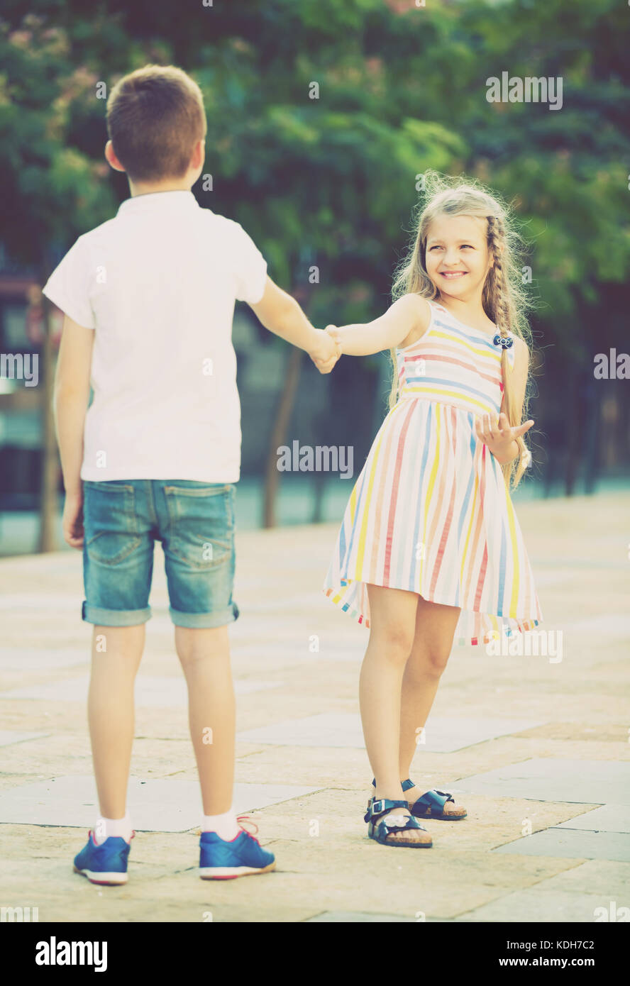 happy smiling girl in elementary school age dancing together with ...