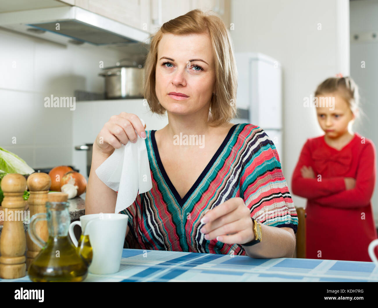 Portrait of offended mother and female child indoors Stock Photo - Alamy