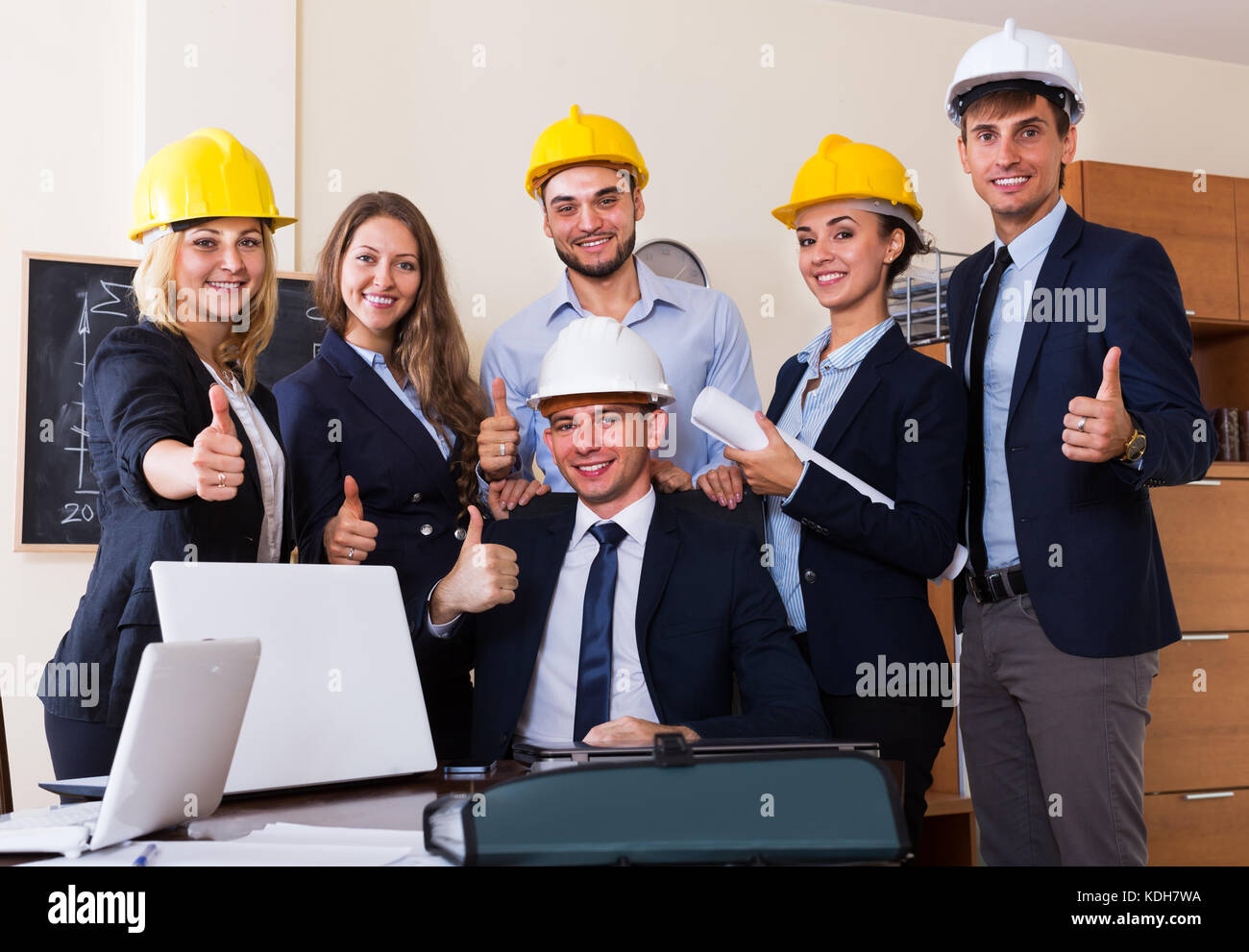 Professional planners with helmets posing at architecture bureau Stock ...