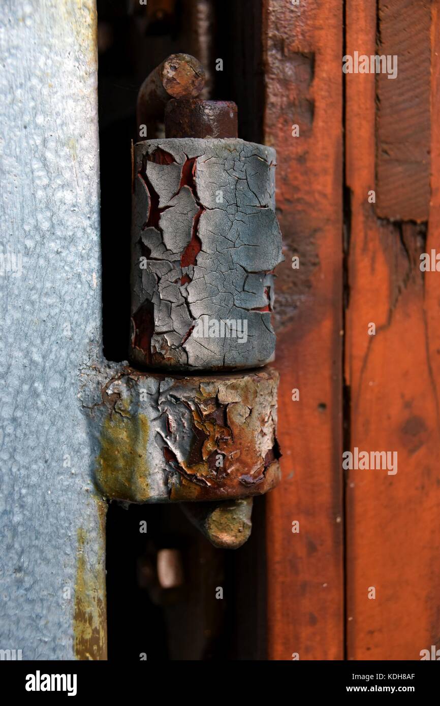 old and rusty door hinge, close-up of rusty door hinge with peeled ...