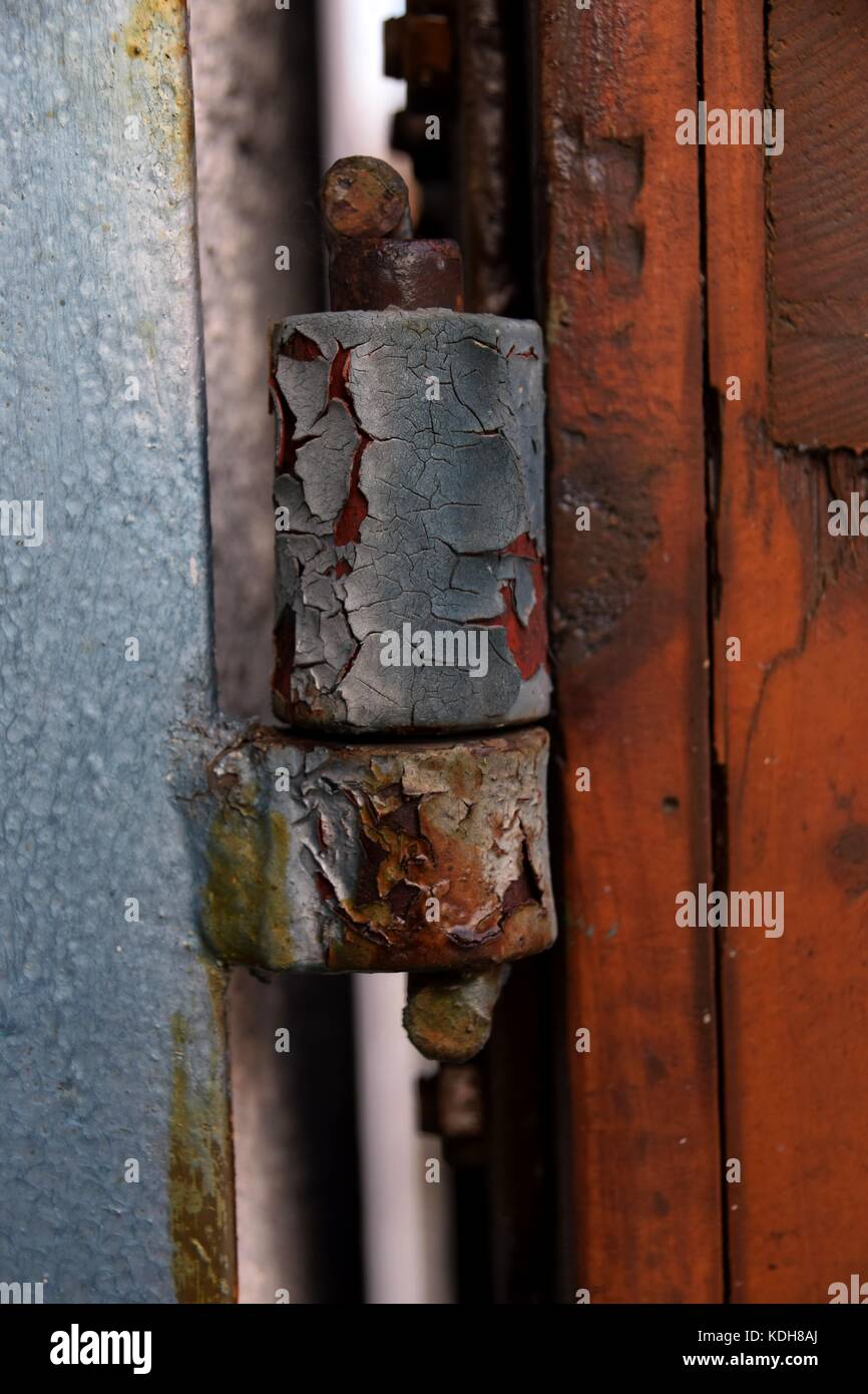 old and rusty door hinge, close-up of rusty door hinge with peeled ...
