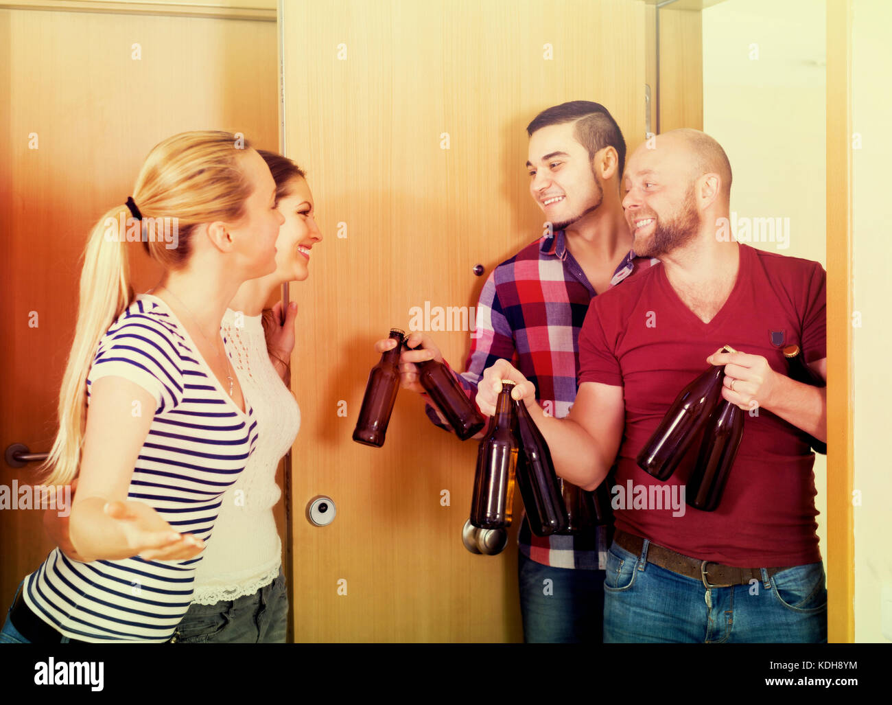 Friends gathering together at house booze party Stock Photo - Alamy