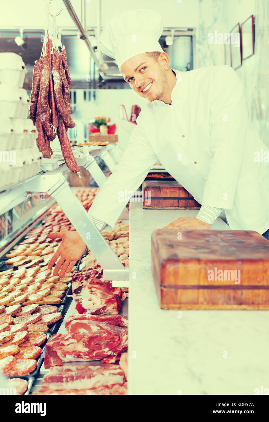 happy chief in professional clothing cooking fresh meat Stock Photo - Alamy