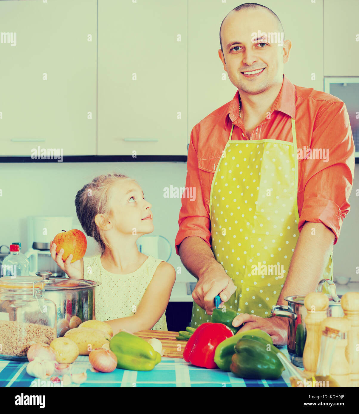 Adult man and happy child cooking in domestic kitchen Stock Photo - Alamy
