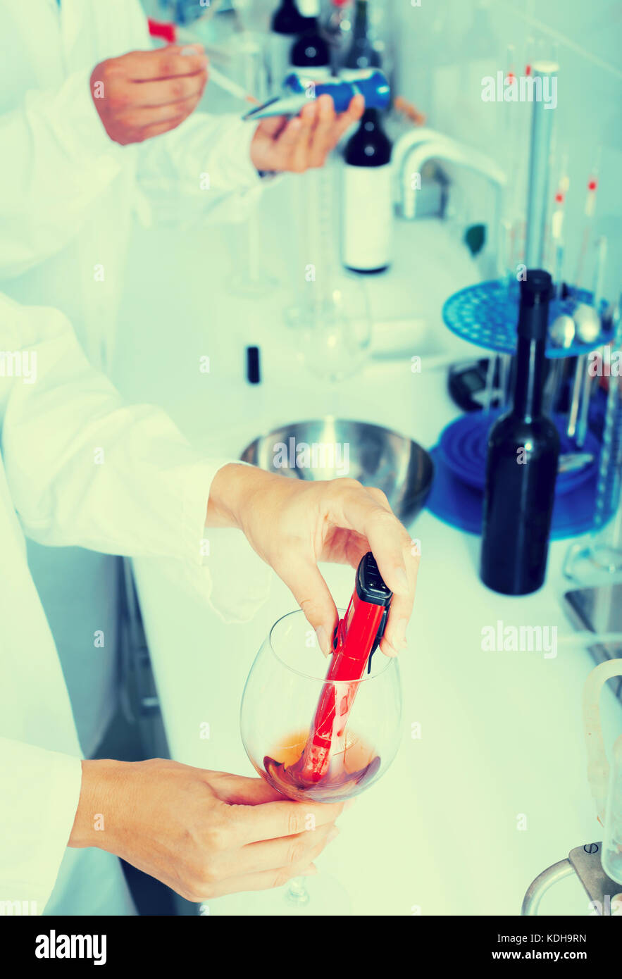 Close up on hands testing quality in chemical lab Stock Photo - Alamy