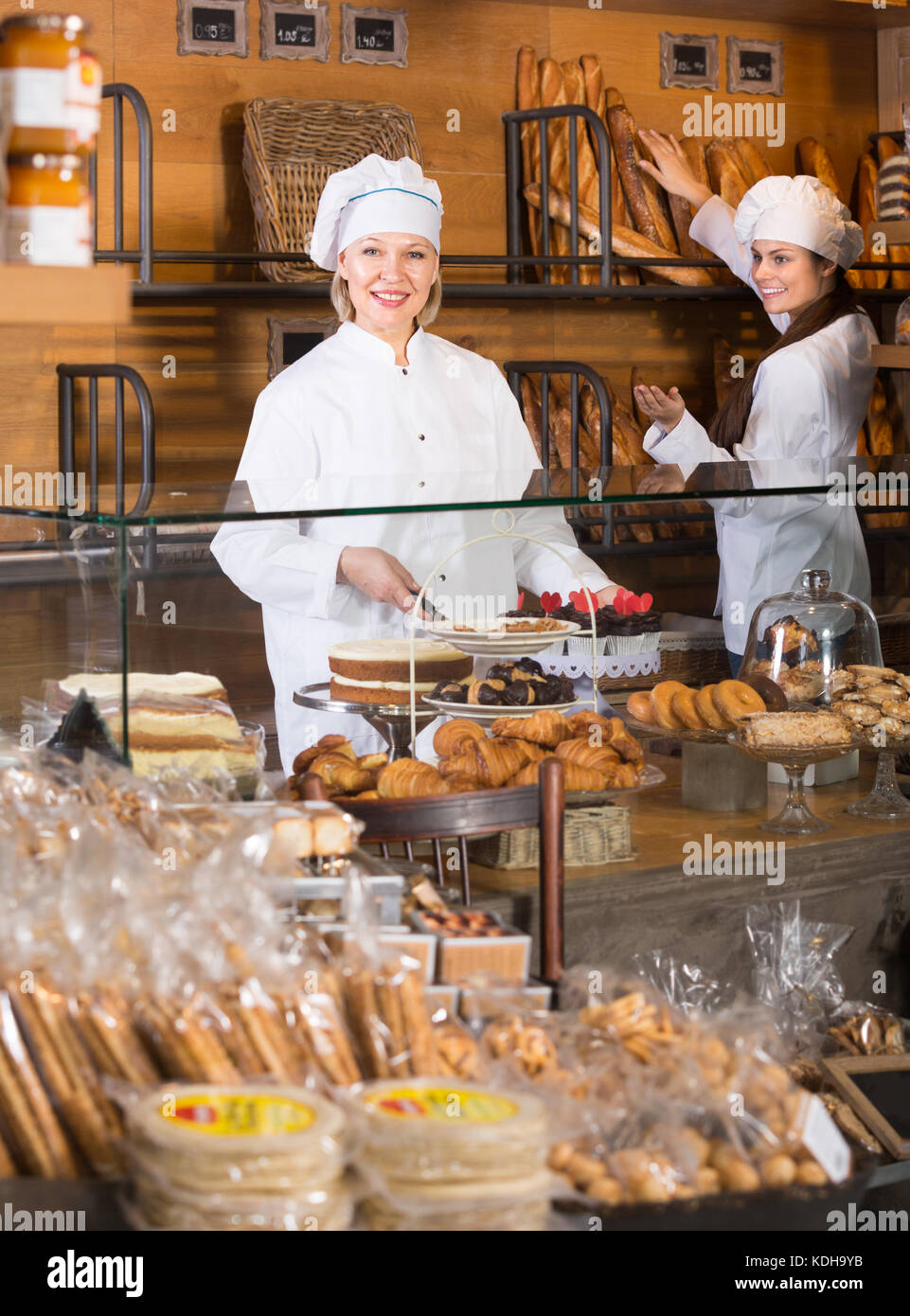 Bakery staff offering bread and pastry for sale Stock Photo - Alamy