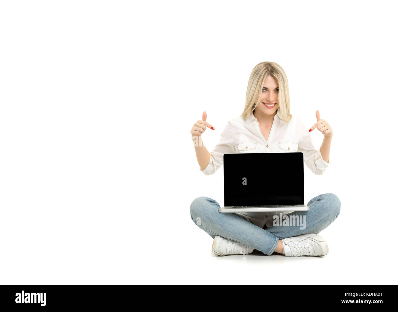Young blonde woman showing blank laptop computer screen sitting on the ...