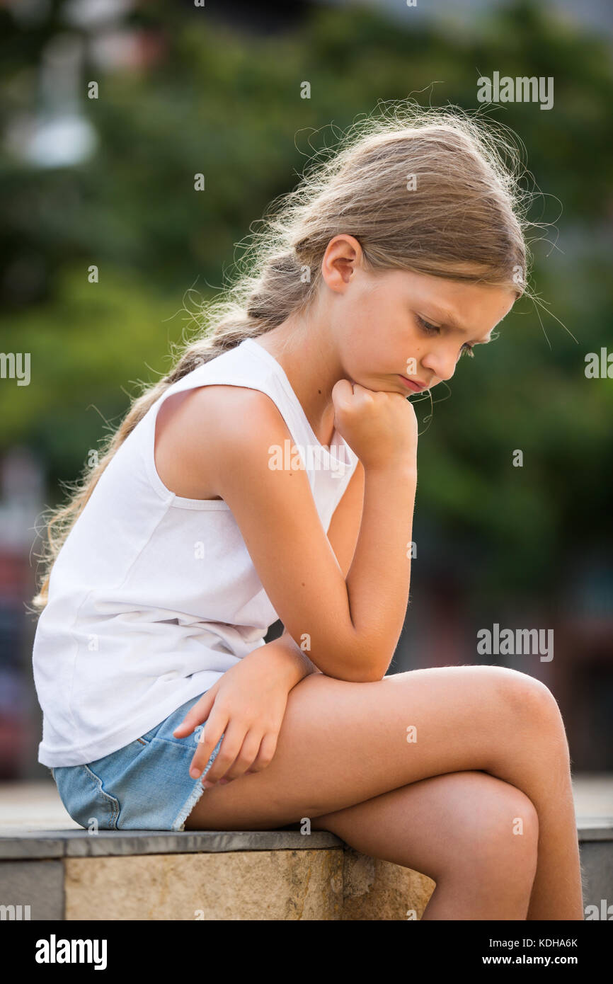 portrait of sad girl being alone and worried outdoors Stock Photo - Alamy