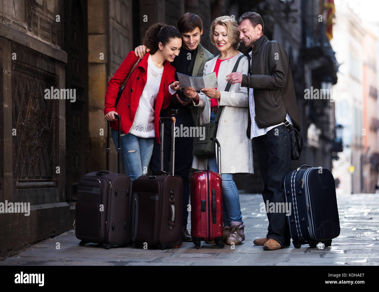 Two family couples reading city map and sightseeing outdoors Stock ...