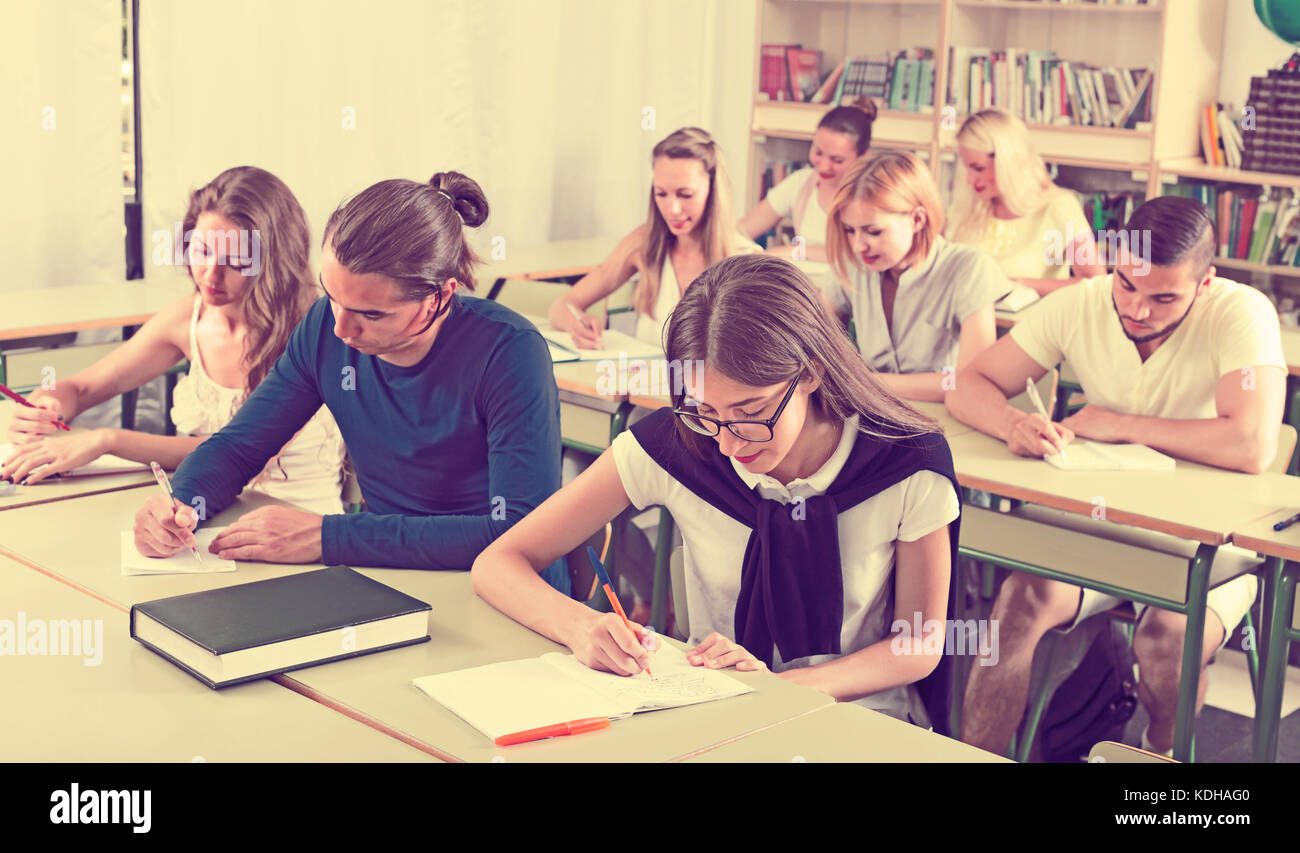 Group of adult pupils studying together in classroom Stock Photo - Alamy