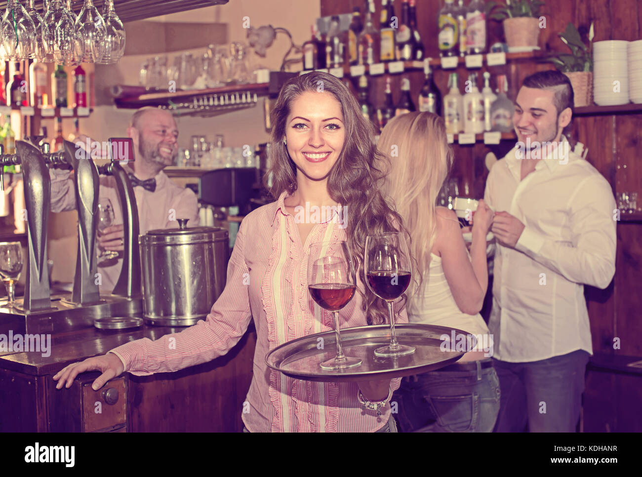 Portrait of happy smiling girl working in modern bar as waitress Stock ...