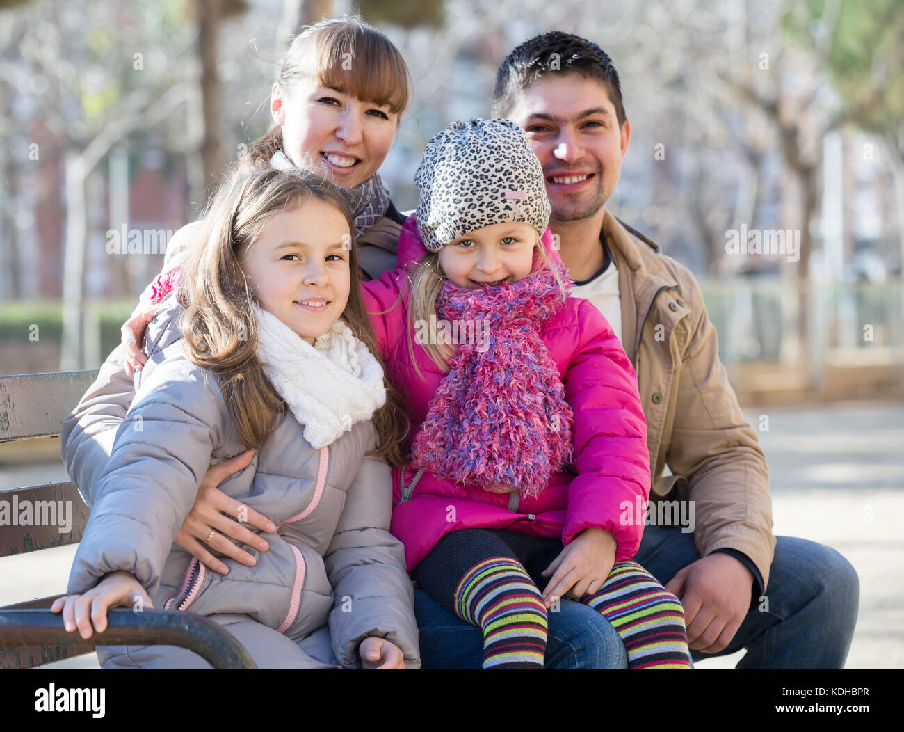 positive european family with two girls outdoors in sunny fall day ...