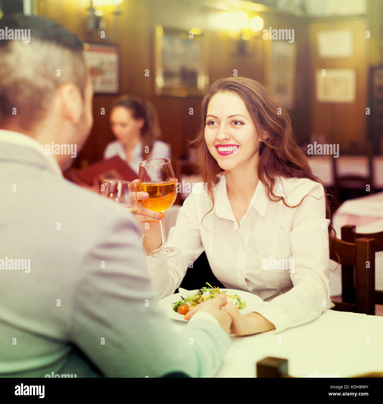 Young happy woman having romantic dinner with guy in restaurant Stock ...