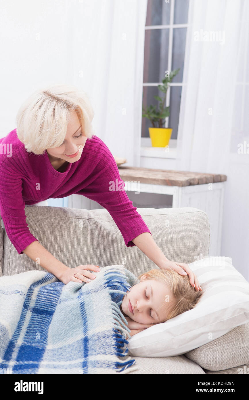 Caring mom caressing her little sleepy sick child Stock Photo - Alamy
