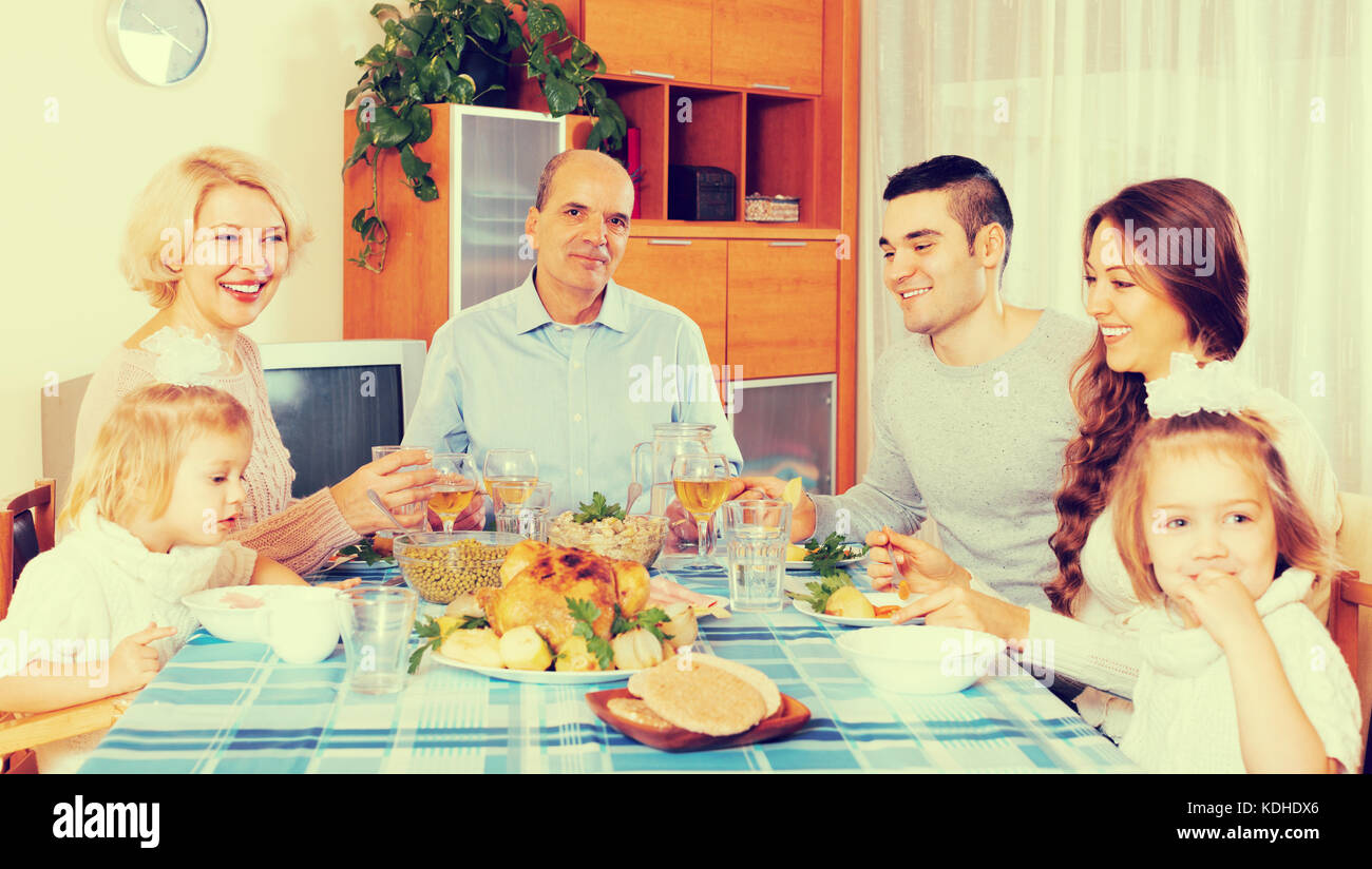 Multigenerational european family having dinner at home Stock Photo - Alamy