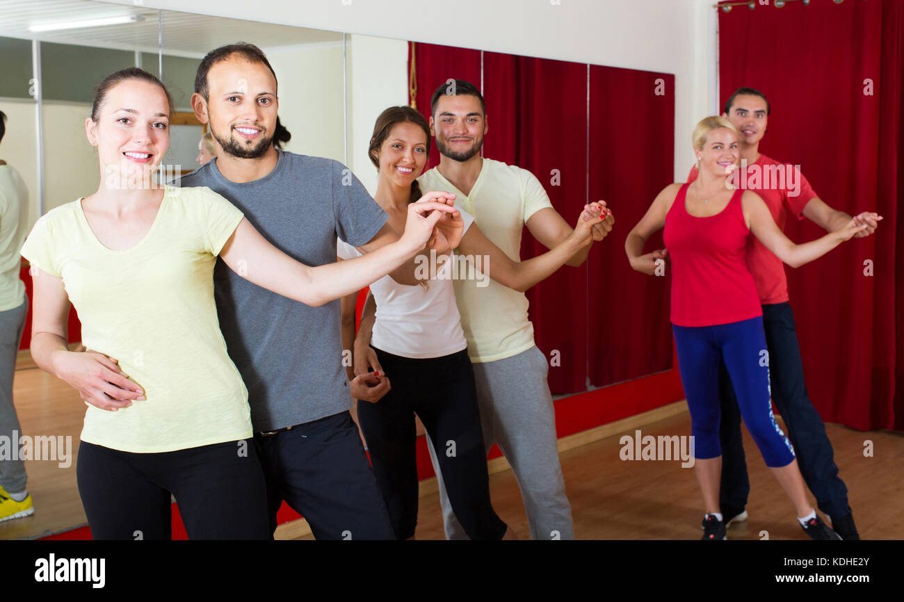 Group of happy russian people dancing salsa in studio Stock Photo - Alamy