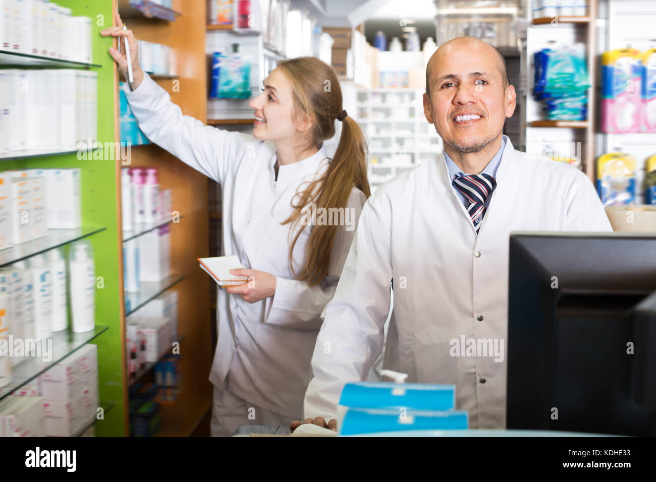 Happy pharmacist and pharmacy technician helping in drugstore Stock ...