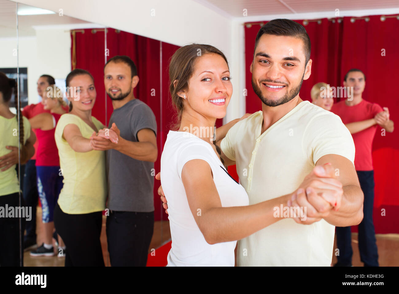 Positive happy young adults dancing pair dance Stock Photo - Alamy