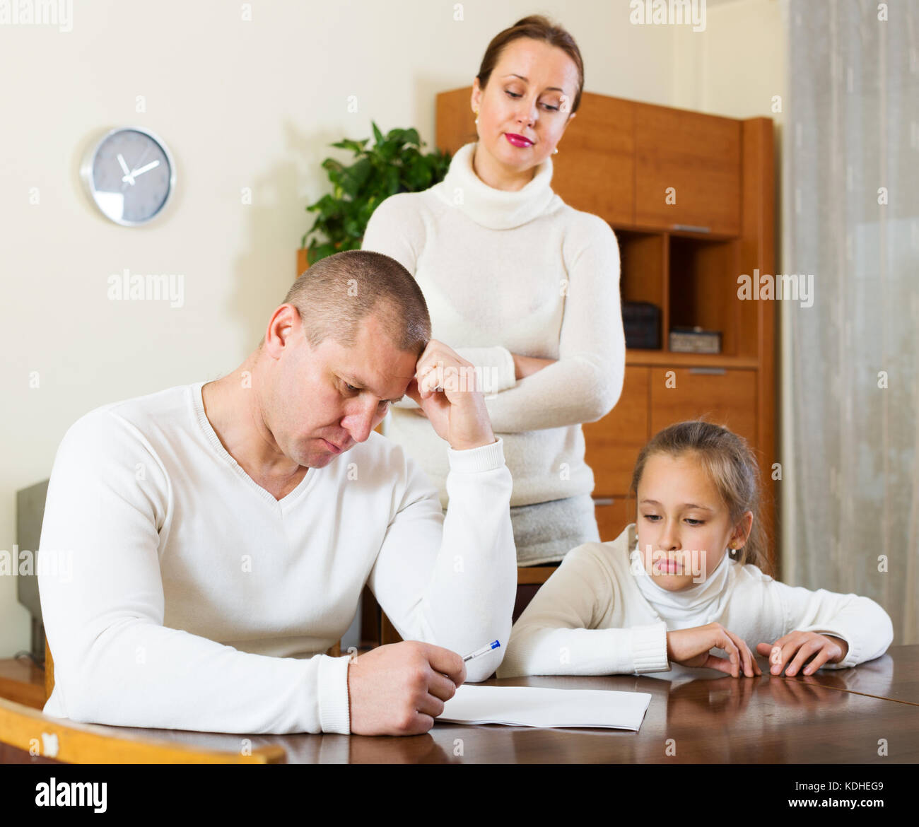 Sad family with documents having financial problems Stock Photo - Alamy