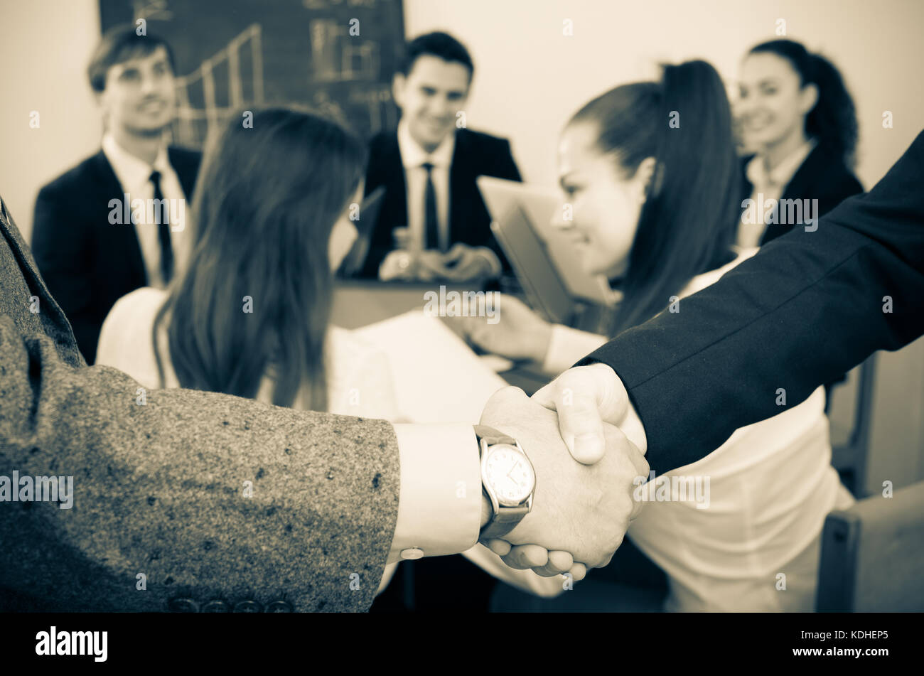 Two managers shaking hands and celebrating successful deal Stock Photo ...