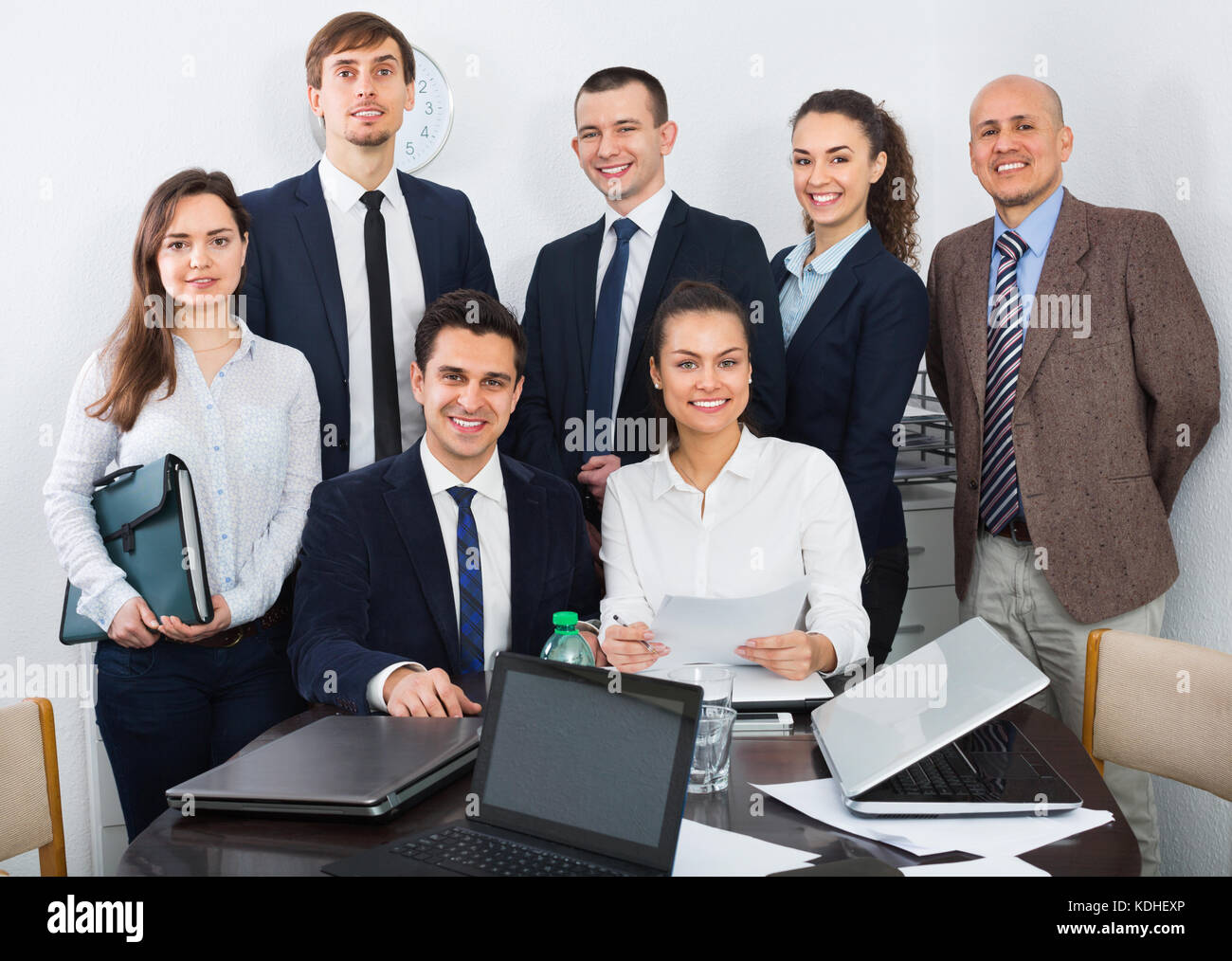 Portrait of smiling business specialist and secretary working in modern ...