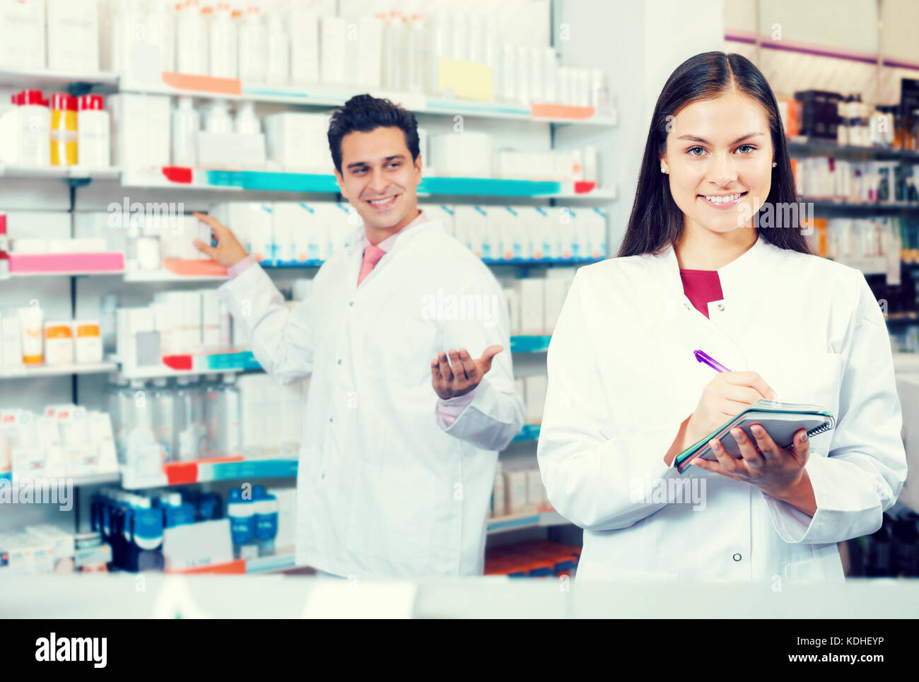 Two successful friendly pharmacists working in modern farmacy Stock ...