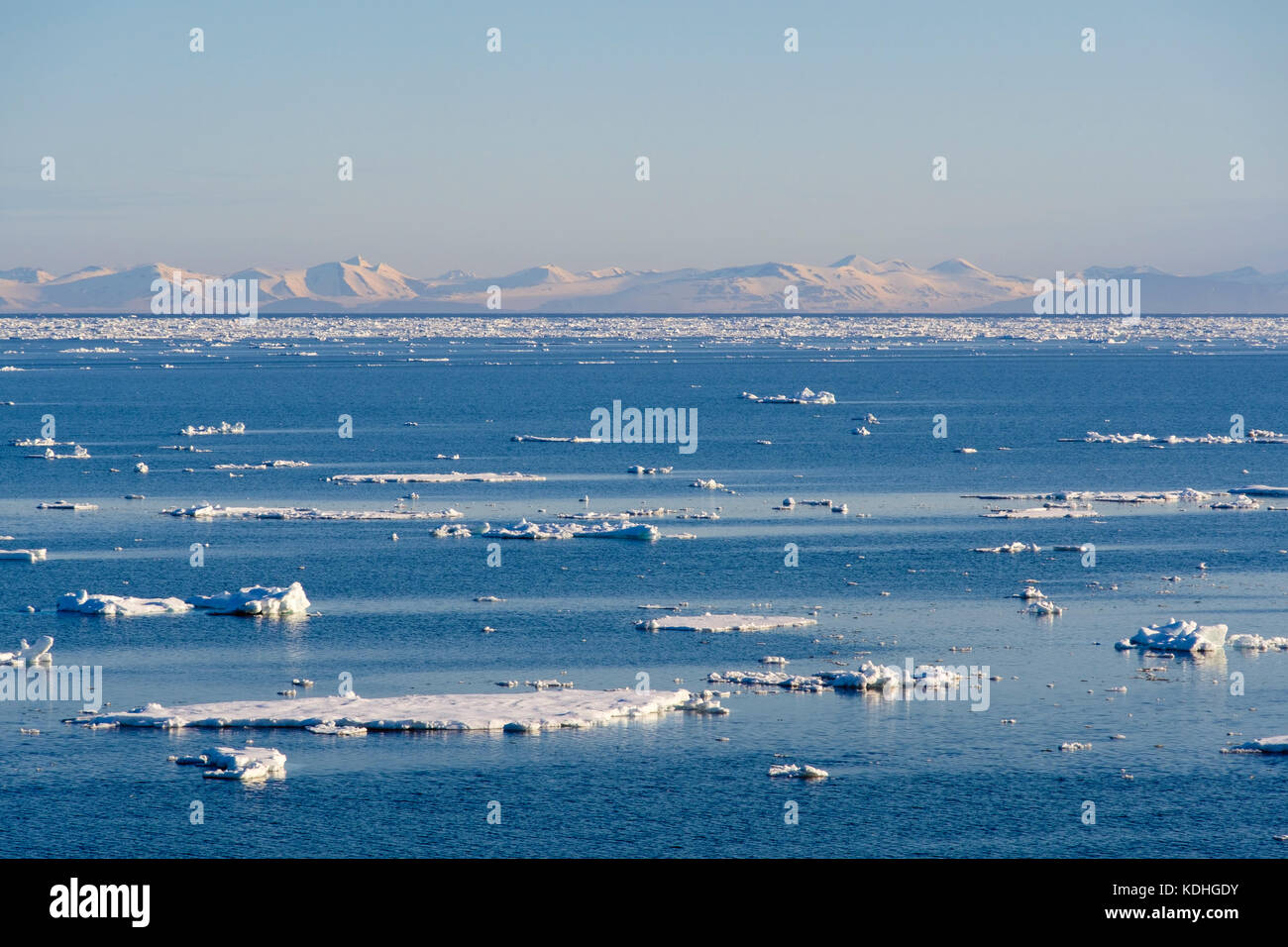 Offshore view across sea ice floe to mountains on east coast at 2 am in ...