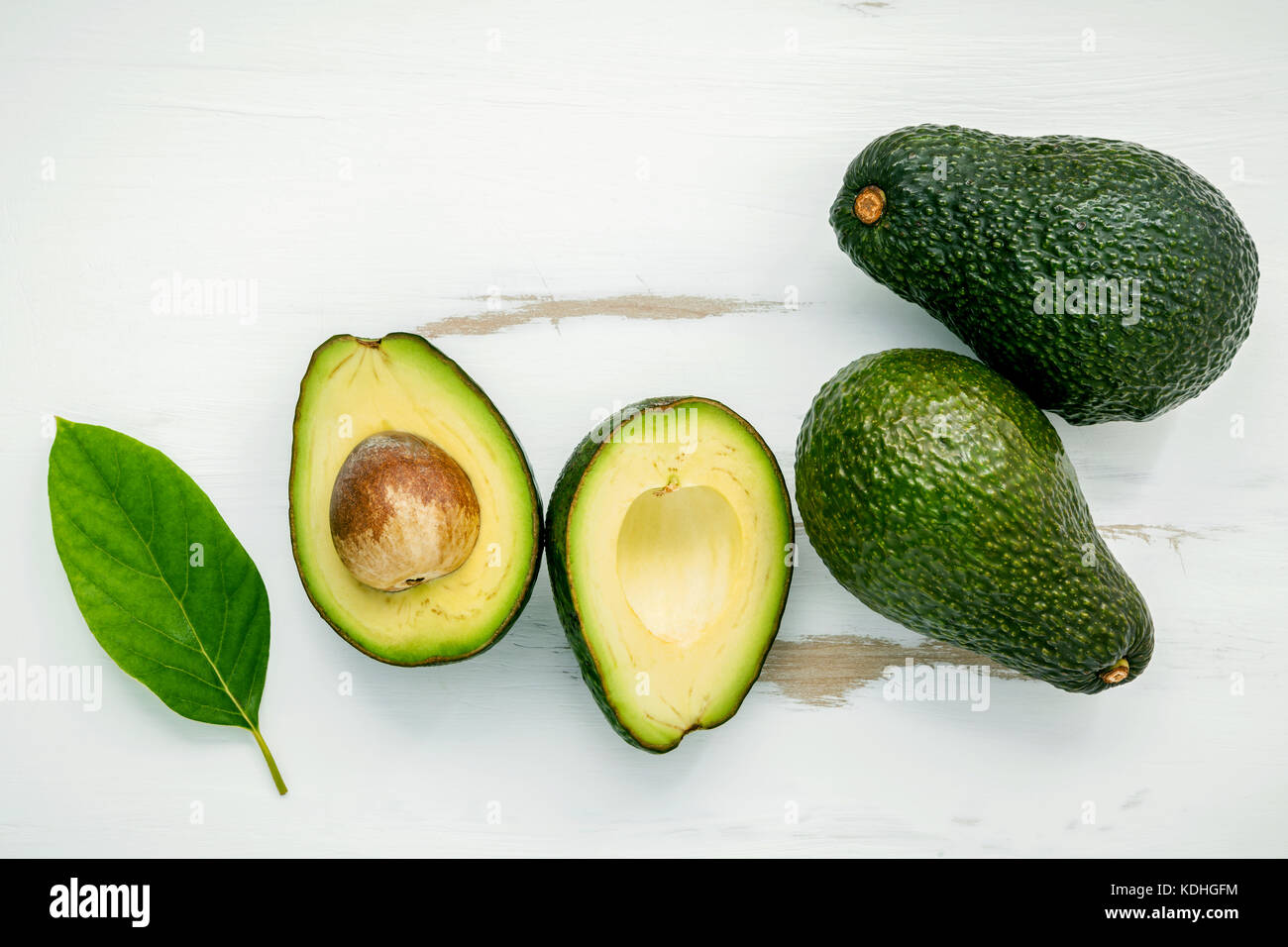 Healthy food concept . Close Up fresh avocado and leaves on white ...