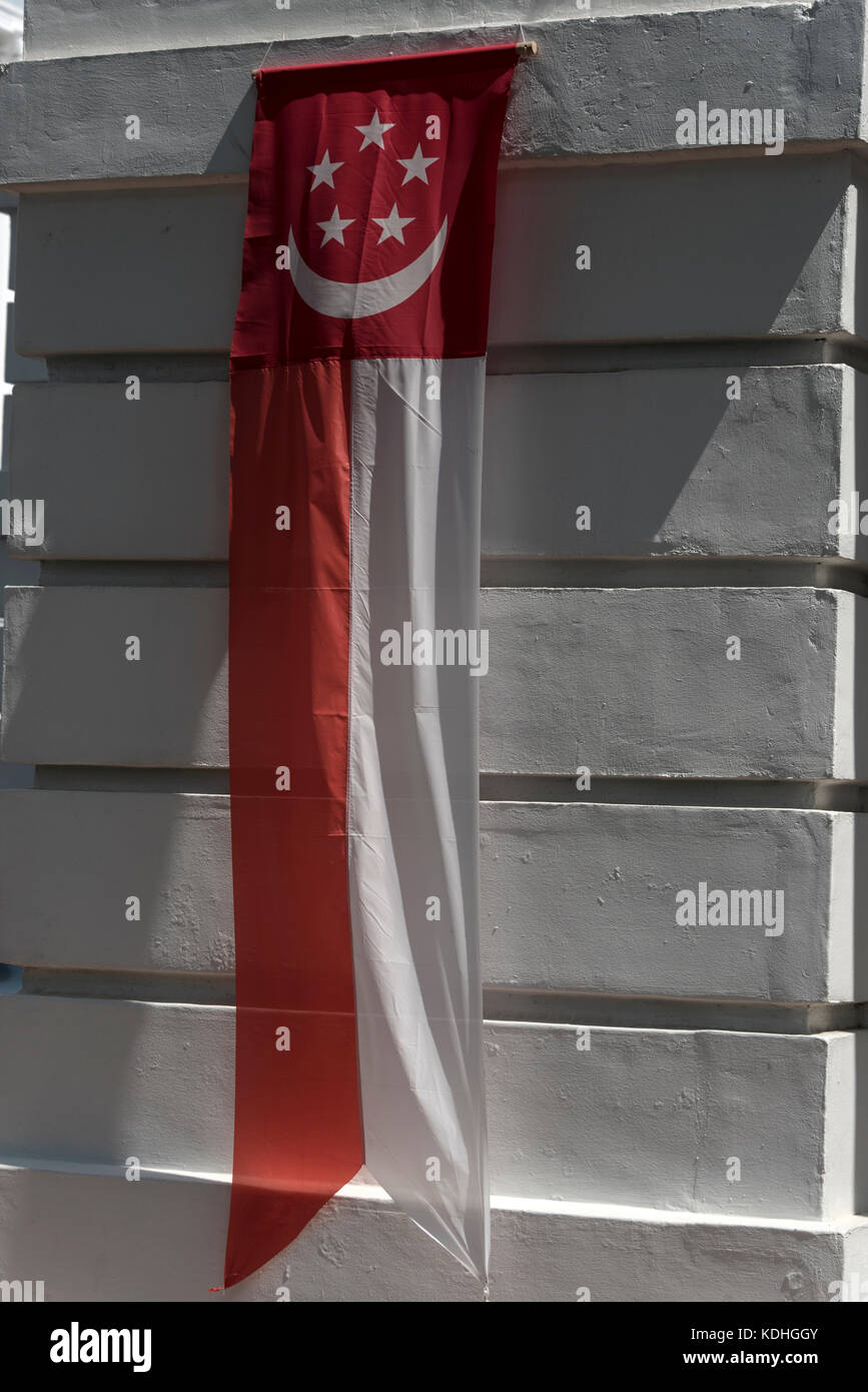 A National Singapore flag banner hanging on a government building in ...