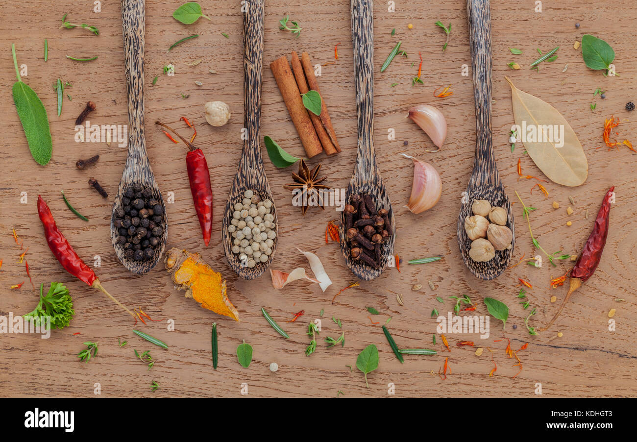 Assorted of spices in wooden spoon black pepper ,white pepper, black ...