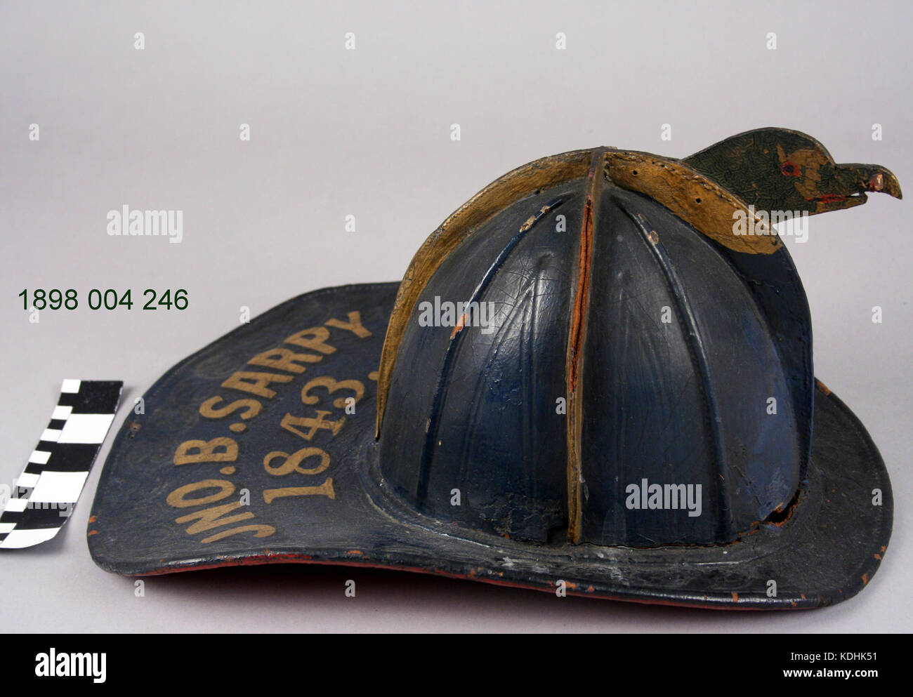 This painted leather fire hat, worn by John Sarpy, represents a piece ...