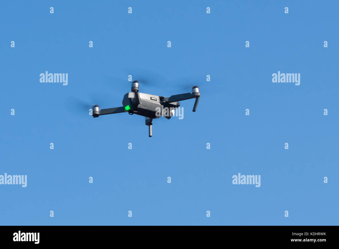 Lonely drone flying in blue sky Stock Photo - Alamy