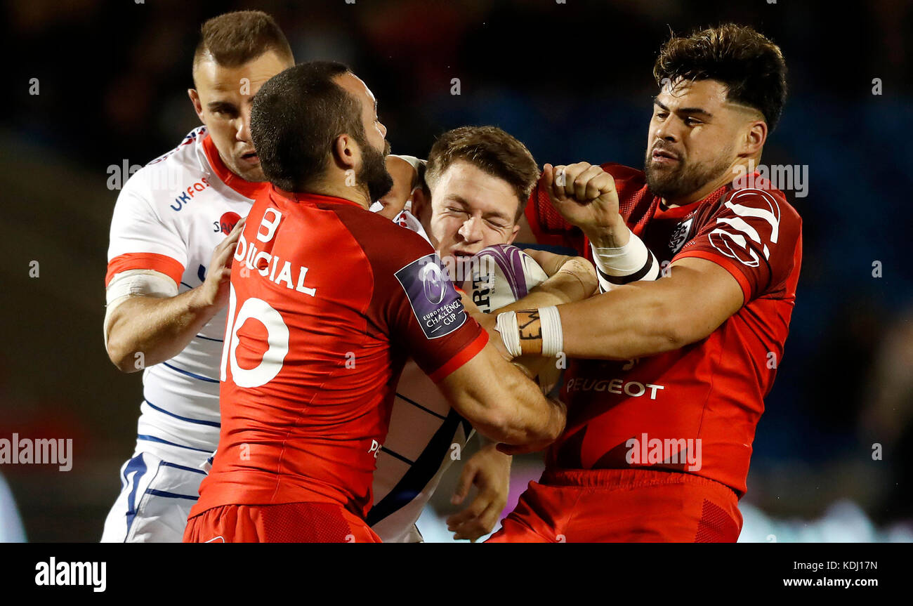 Sale Sharks' Sam James is tackled by Toulouse's Jeam-Marc Doussain ...