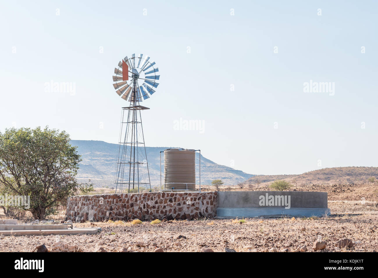 A farm scene with a water-pumping windmill and dam at Bergsig, a small ...