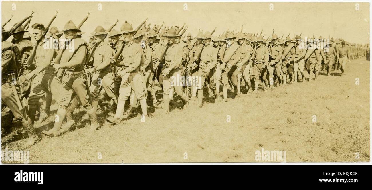 Soldiers Marching In Formation With Rifles While Others Look On Stock ...