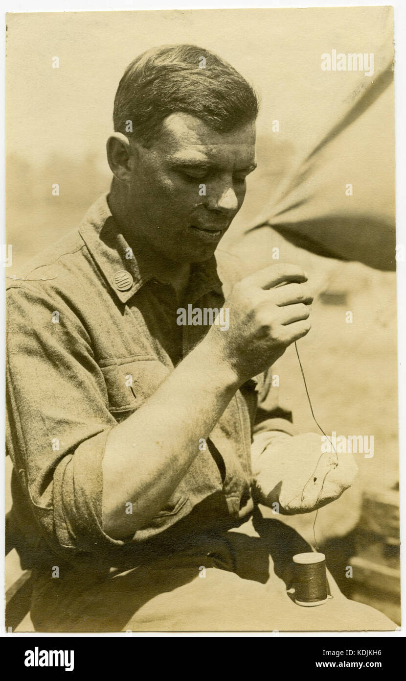 Soldier Using a Needle and Thread to Repair a Sock Stock Photo - Alamy