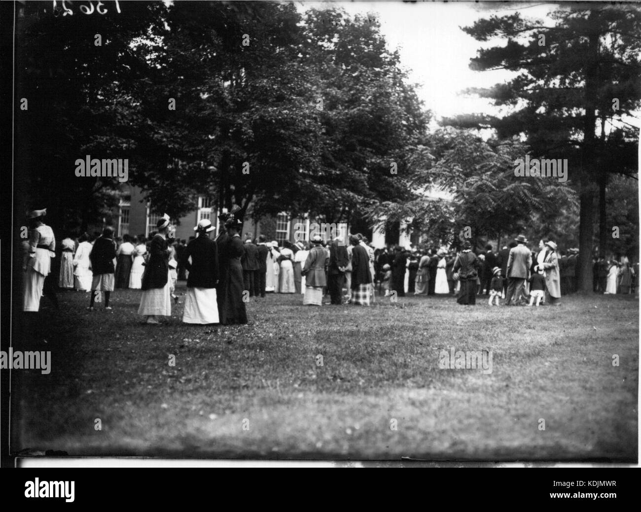 Spectators on lawn outside Administration Building at commencement 1914 ...