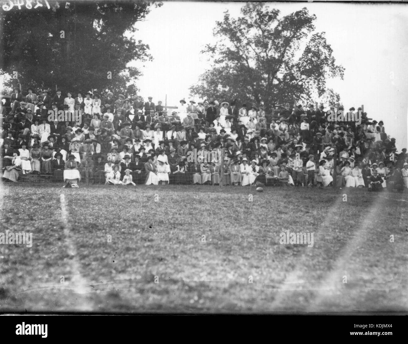 A 1913 photograph showing spectators attending a football game between ...